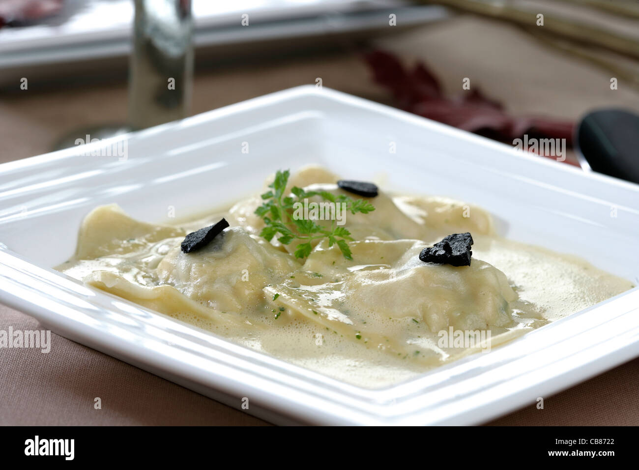 Ravioli stuffed with foie gras, vegetables and partridge with egg sauce ...