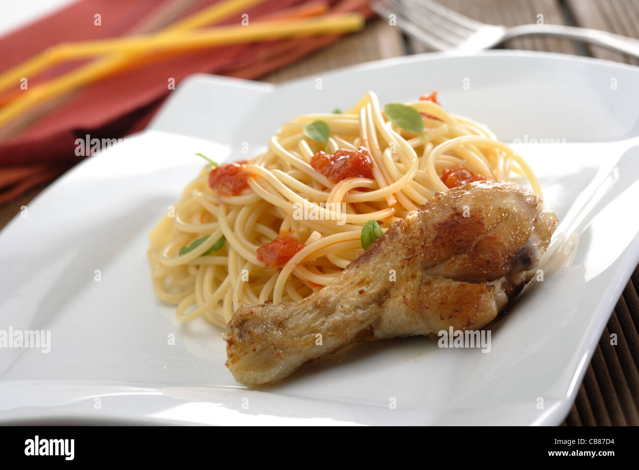 Chicken legs with spaghetti with tomato Stock Photo - Alamy