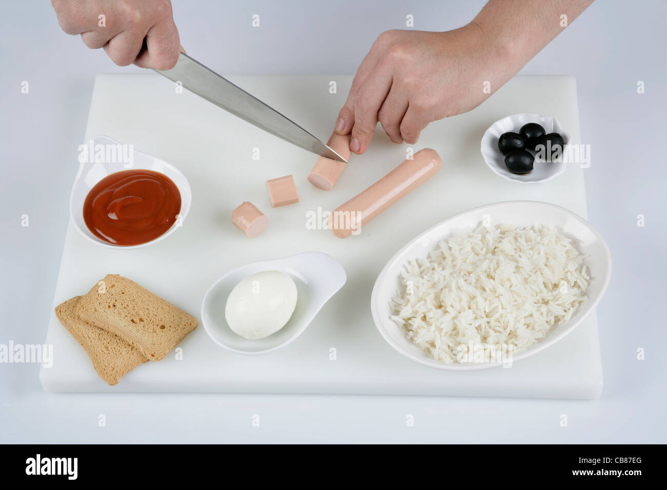 Cutting hot dogs Stock Photo - Alamy