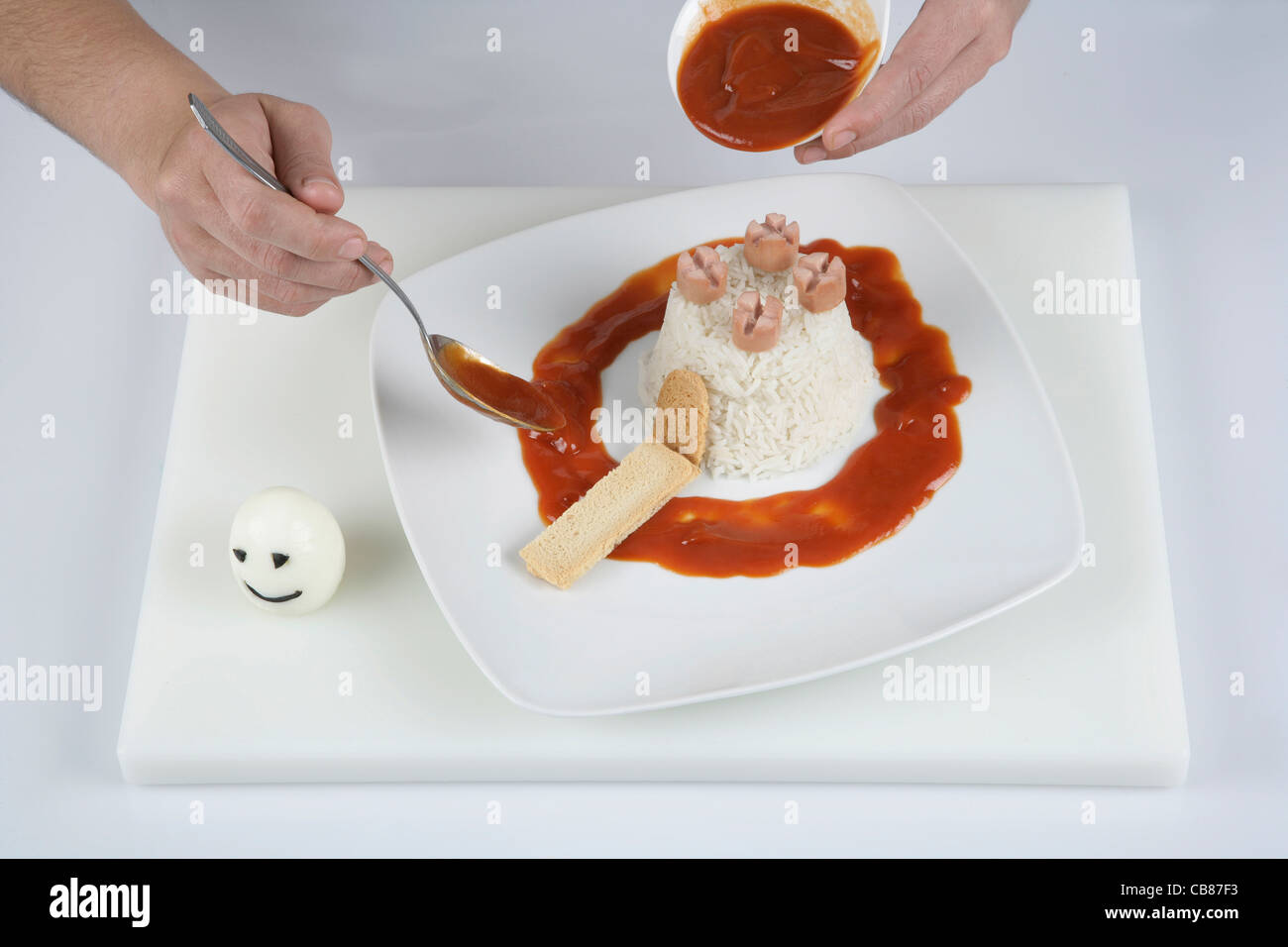 Rice castle, eggs, ketchup, sausage, children Stock Photo - Alamy