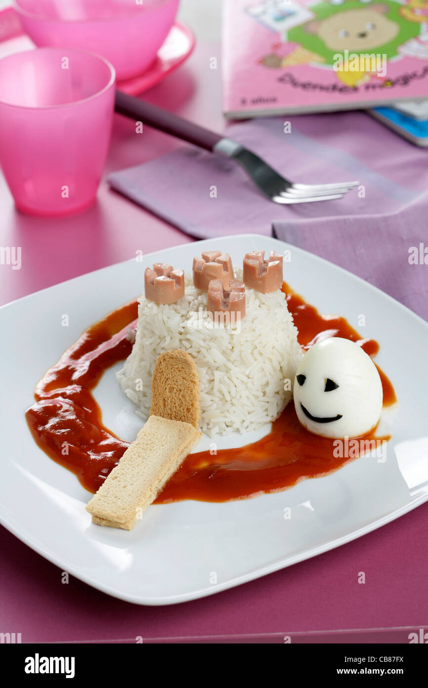 Rice castle, eggs, ketchup, sausage, children Stock Photo - Alamy