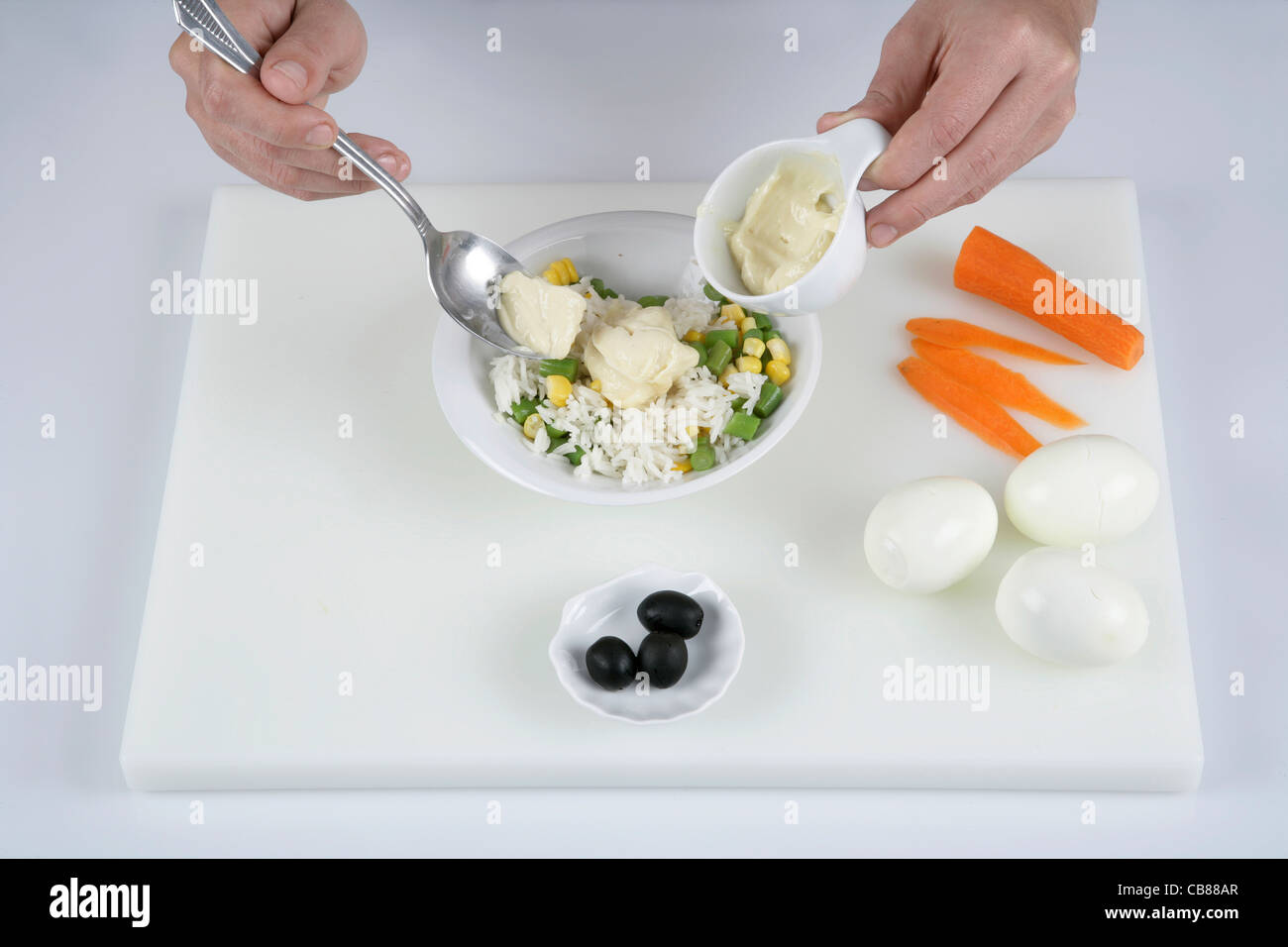 Mixing mayonnaise and rice salad Stock Photo - Alamy
