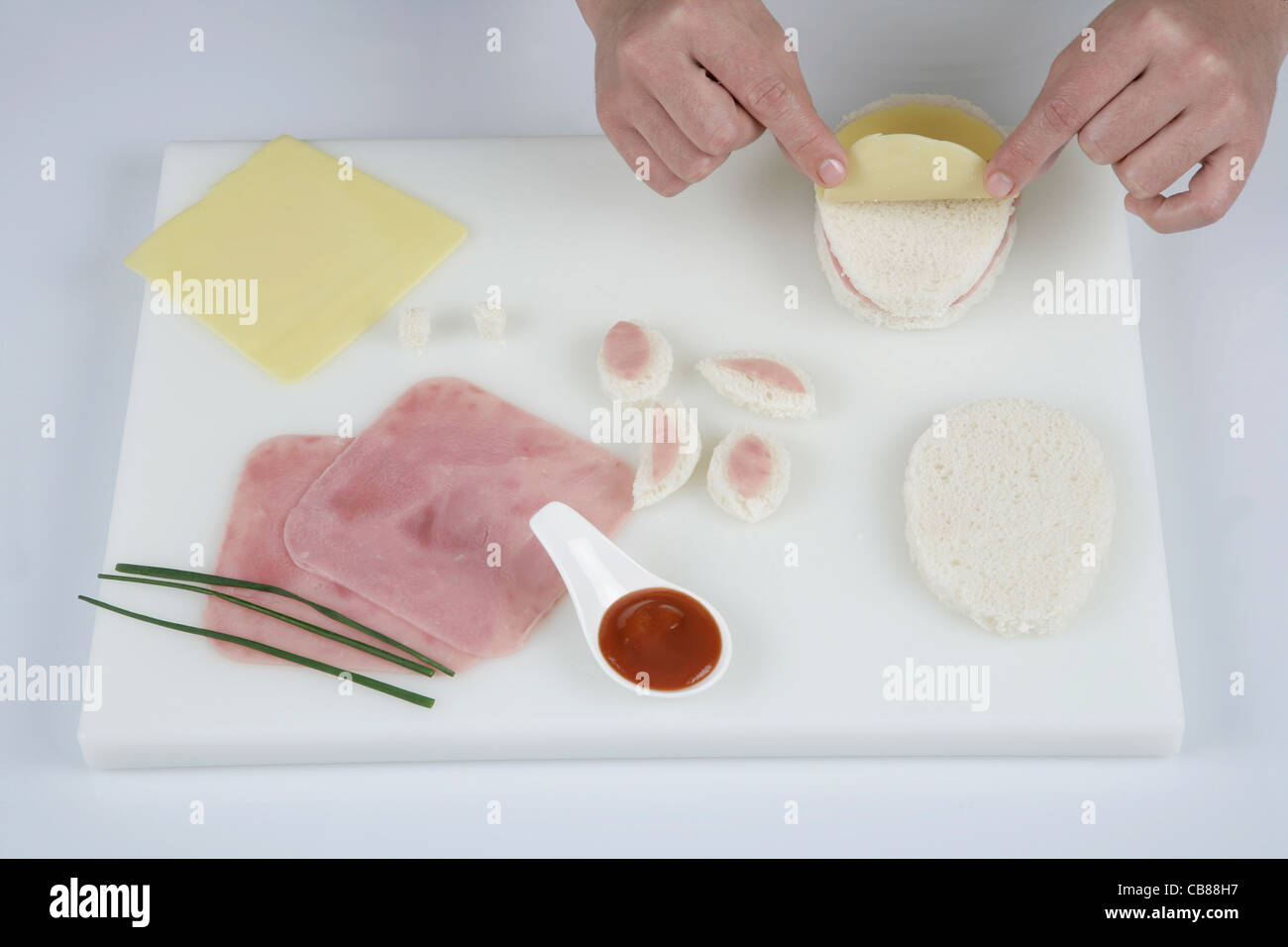 Adding cheese on sliced bread, children Stock Photo - Alamy
