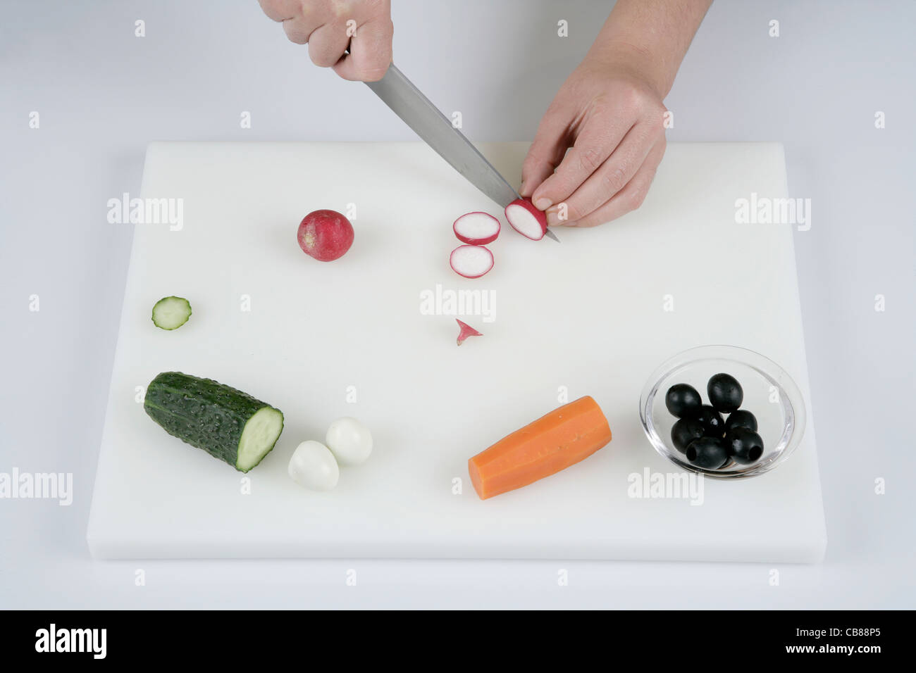 Cutting radishes into slices Stock Photo - Alamy