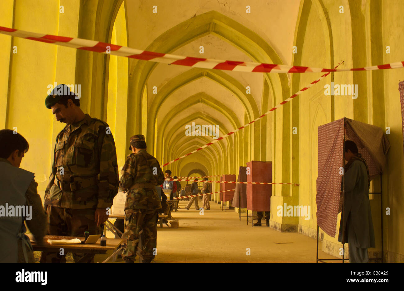 An Afghan soldier casts his ballot in a mosque used as a polling ...
