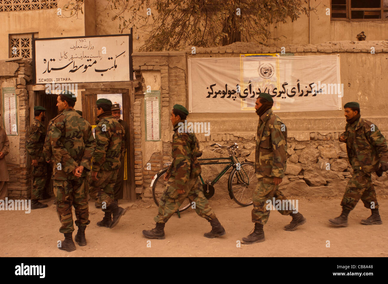 Afghan soldiers enter a polling station to cast their votes in Kabul ...