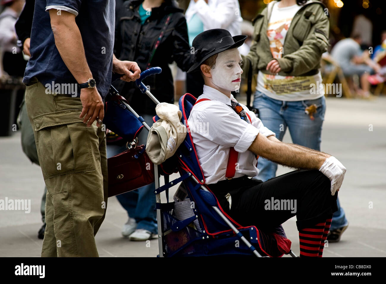 pantomime player sitting in children's buggy in milan, italy Stock ...