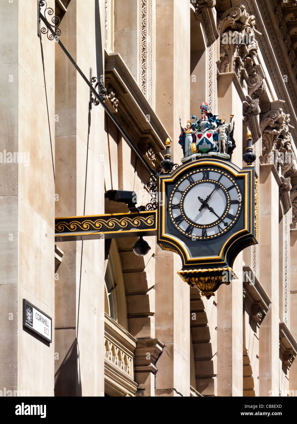 Wall mounted clock outside the Royal Exchange building on Cornhill in ...