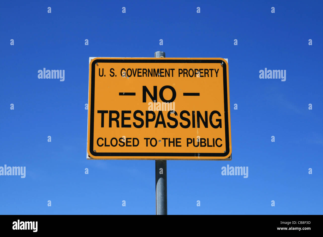 US Government no trespassing sign against a blue sky Stock Photo - Alamy