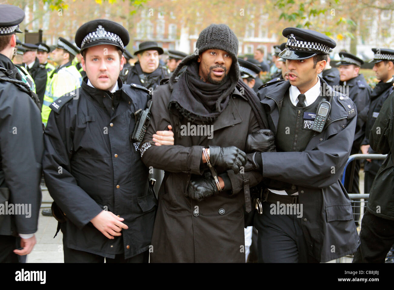 Police lead away handcuffed protester from outside the American Embassy ...