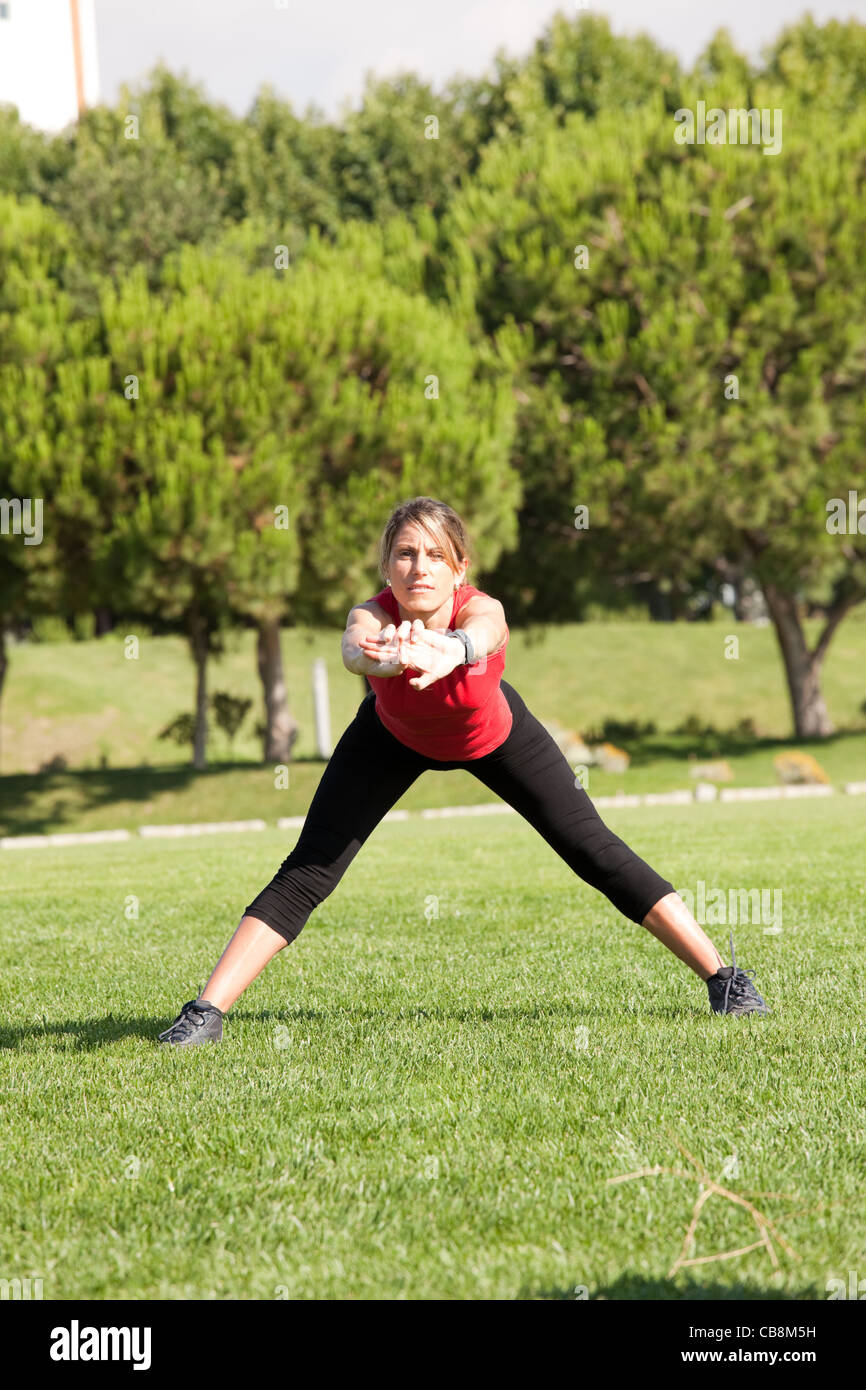 young woman doing some exercise at the park Stock Photo - Alamy