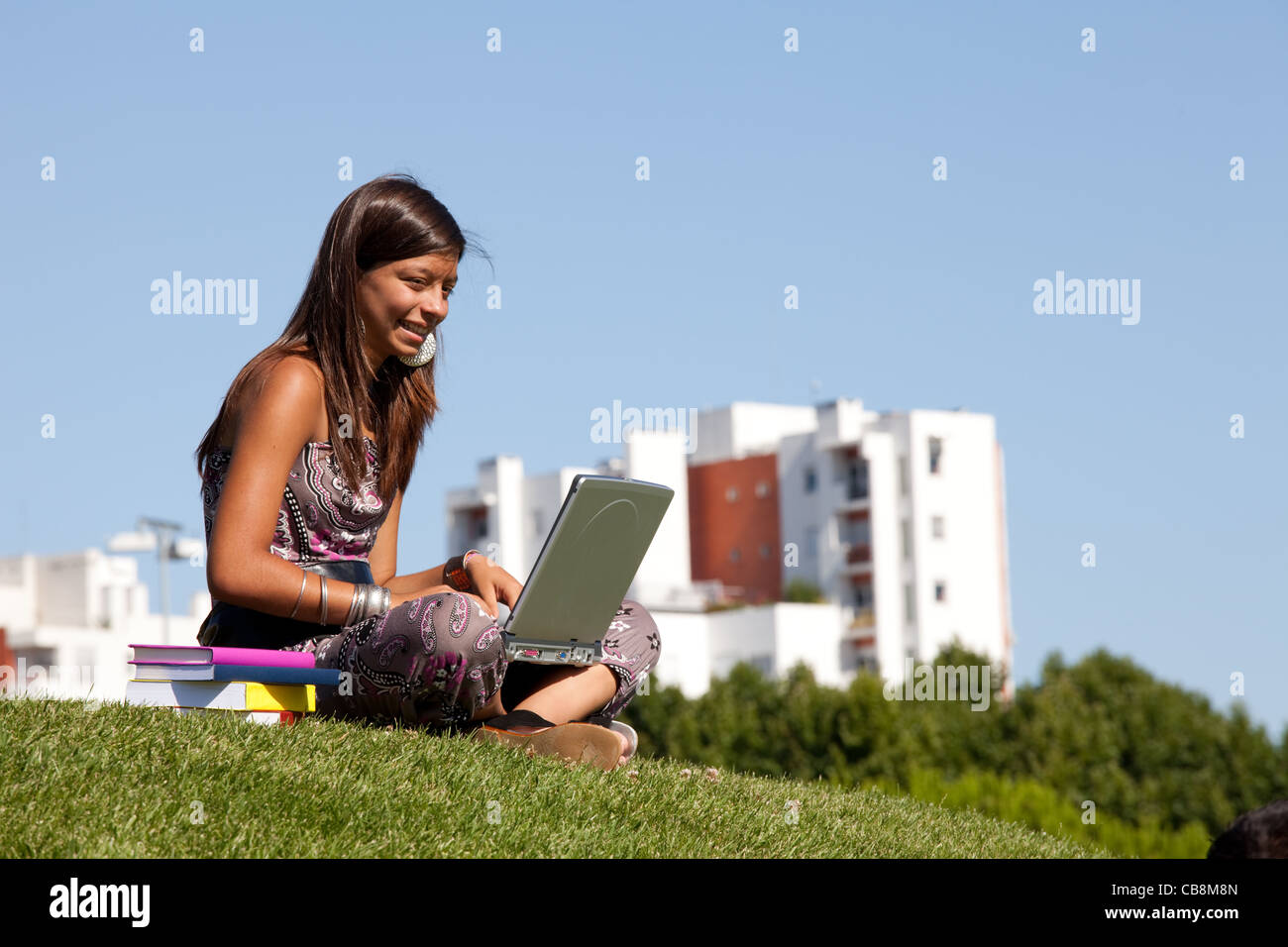 young teenager using the internet at the park on her laptop Stock Photo ...