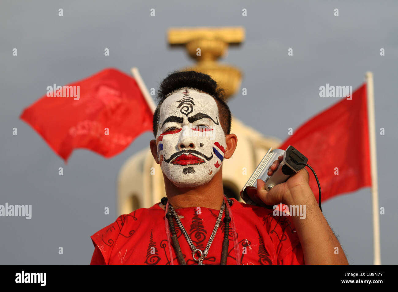 A Red Shirt protester with painted face, stands in front of the ...