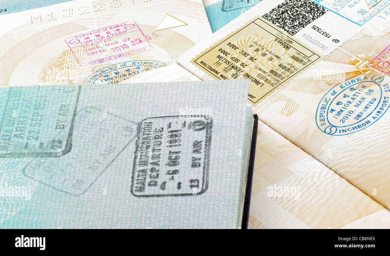 immigration stamps on various passport pages Stock Photo - Alamy