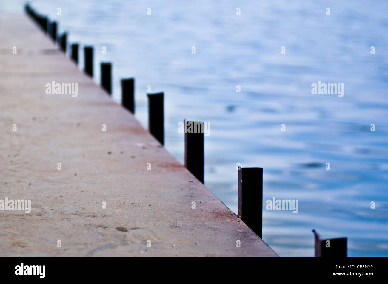 metal pier bridge over blue calm water Stock Photo - Alamy