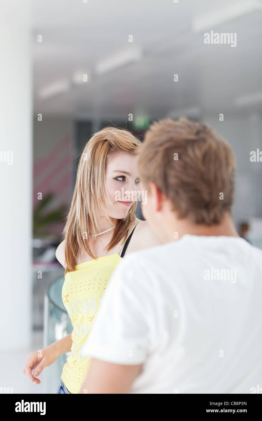 two college students talking/flirting on campus (shallow DOF, color ...