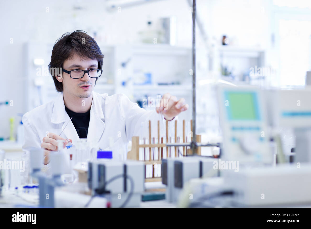 portrait of a male researcher carrying out research in a chemistry lab ...