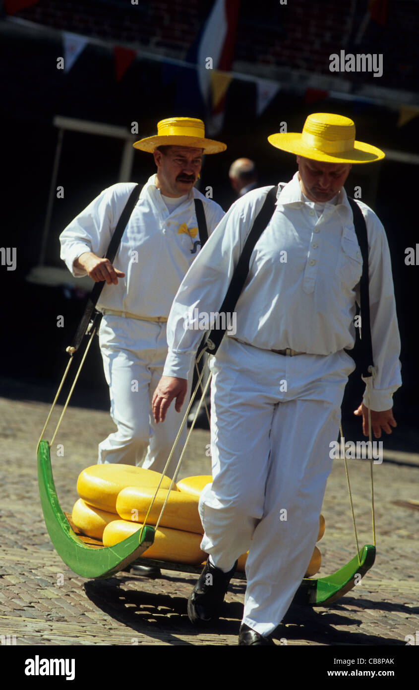 Netherlands, Alkmaar, the cheese market, men carrying blocks of cheese ...