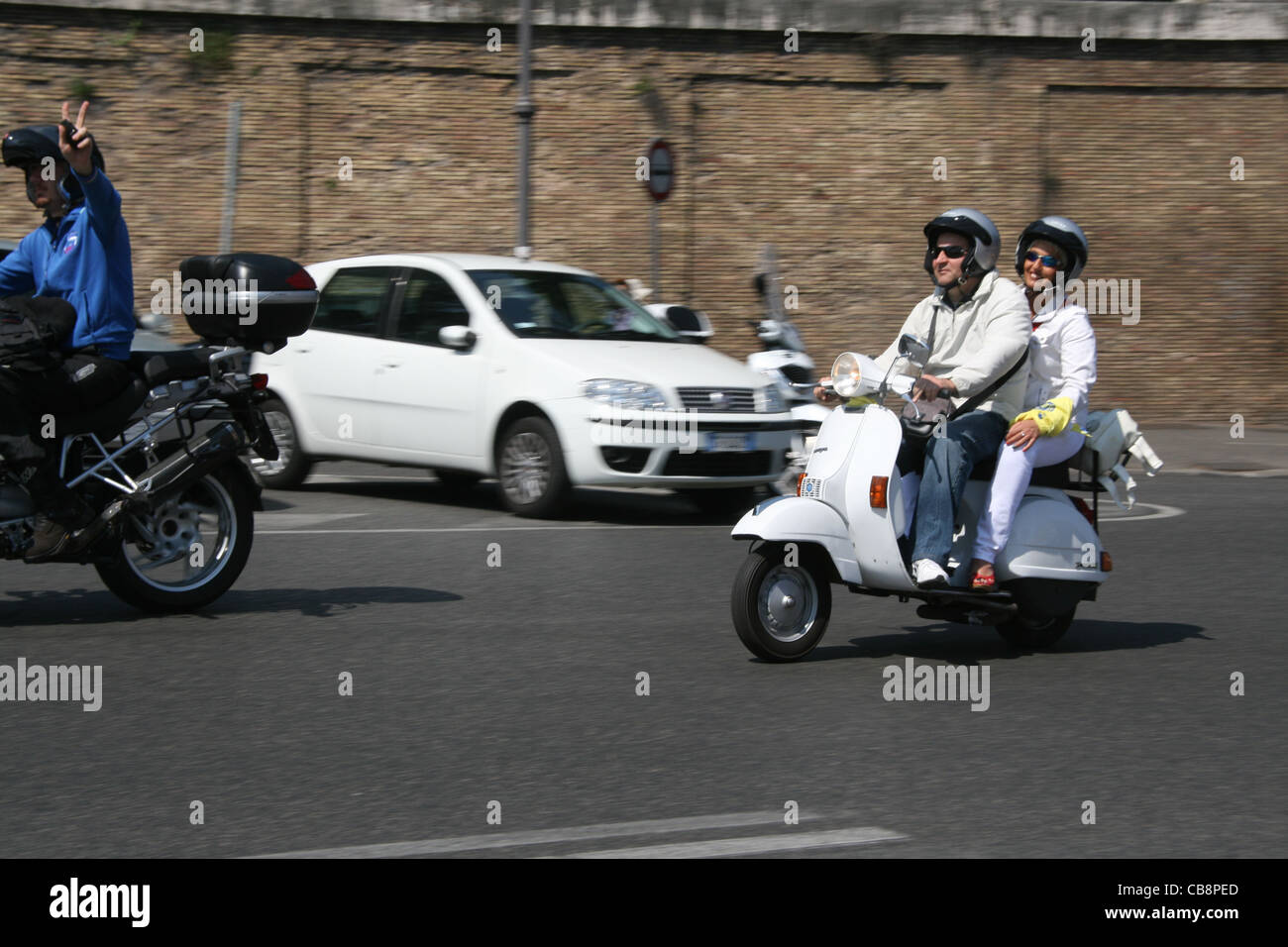 couple riding moped scooter in rome italy Stock Photo - Alamy