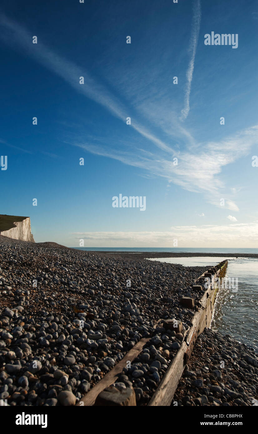The River Cuckmere entering the sea between wooden levees at Cuckmere ...