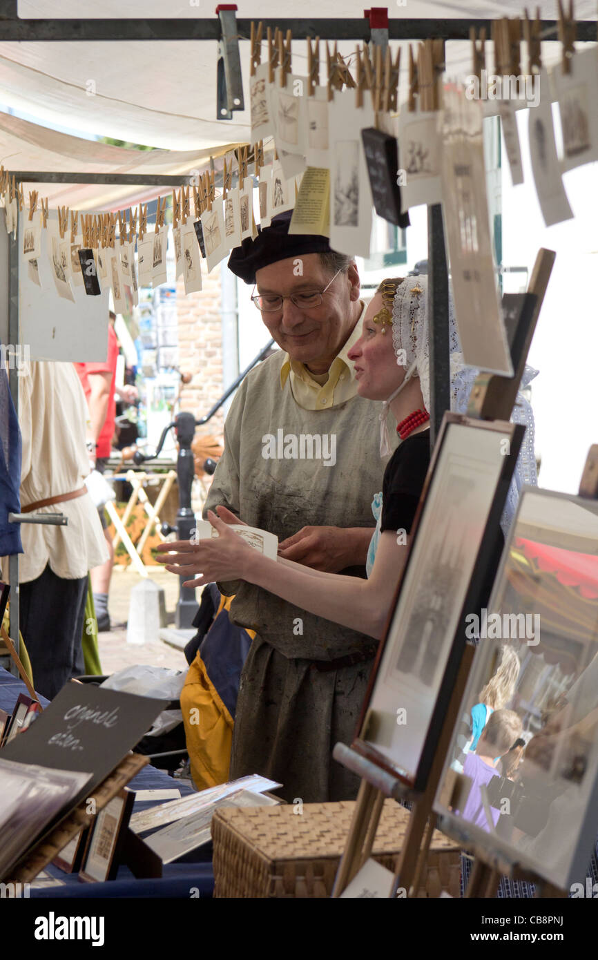 Selling prints at a traditional costume market in the town of Veere ...
