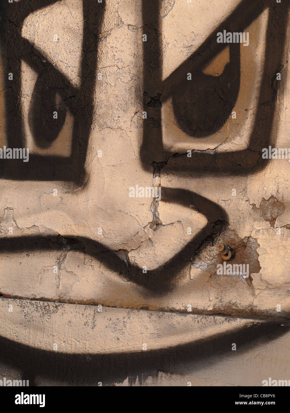 Angry face graffiti on wall in rome italy Stock Photo - Alamy