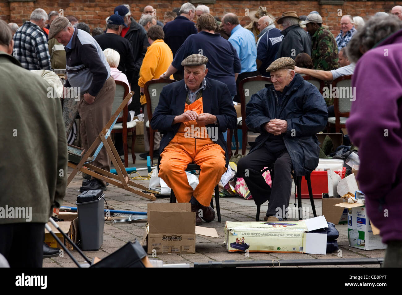 Old Men in Flat Caps Chatting at Junk Auction Stock Photo - Alamy