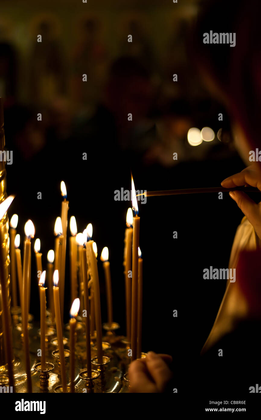 Lady praying in a orthodox church with lightning candle Stock Photo - Alamy