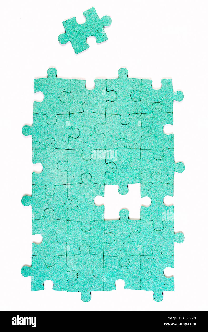 Green puzzle with missing piece Stock Photo - Alamy