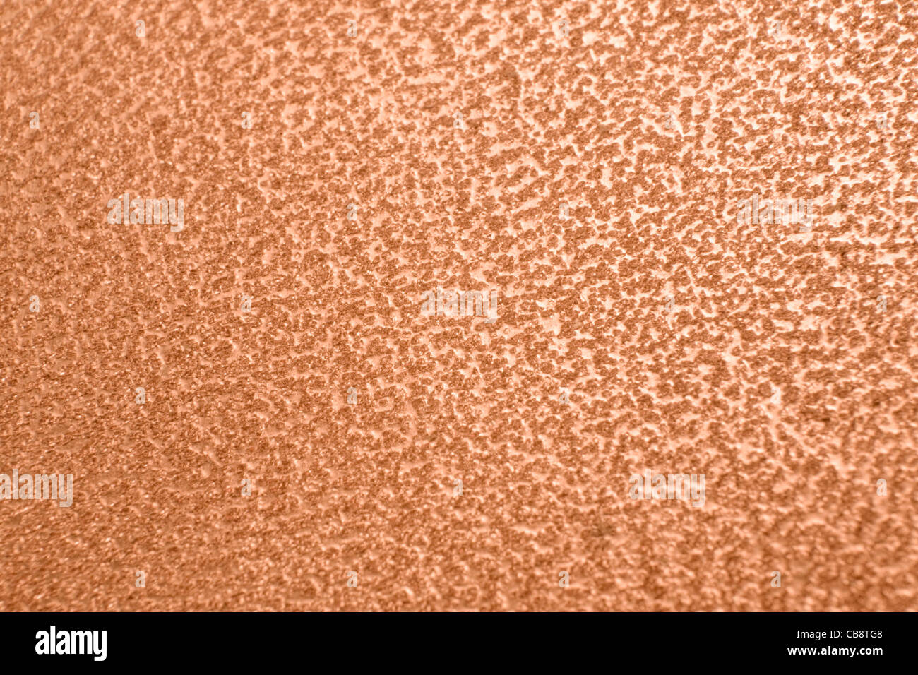abstract metallic background showing the detail of a rough copper plate ...