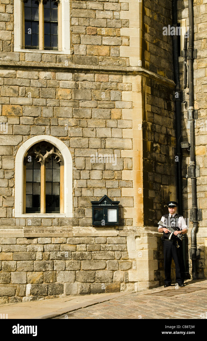 Armed policeman on guard outside St George's chapel Windsor Castle ...