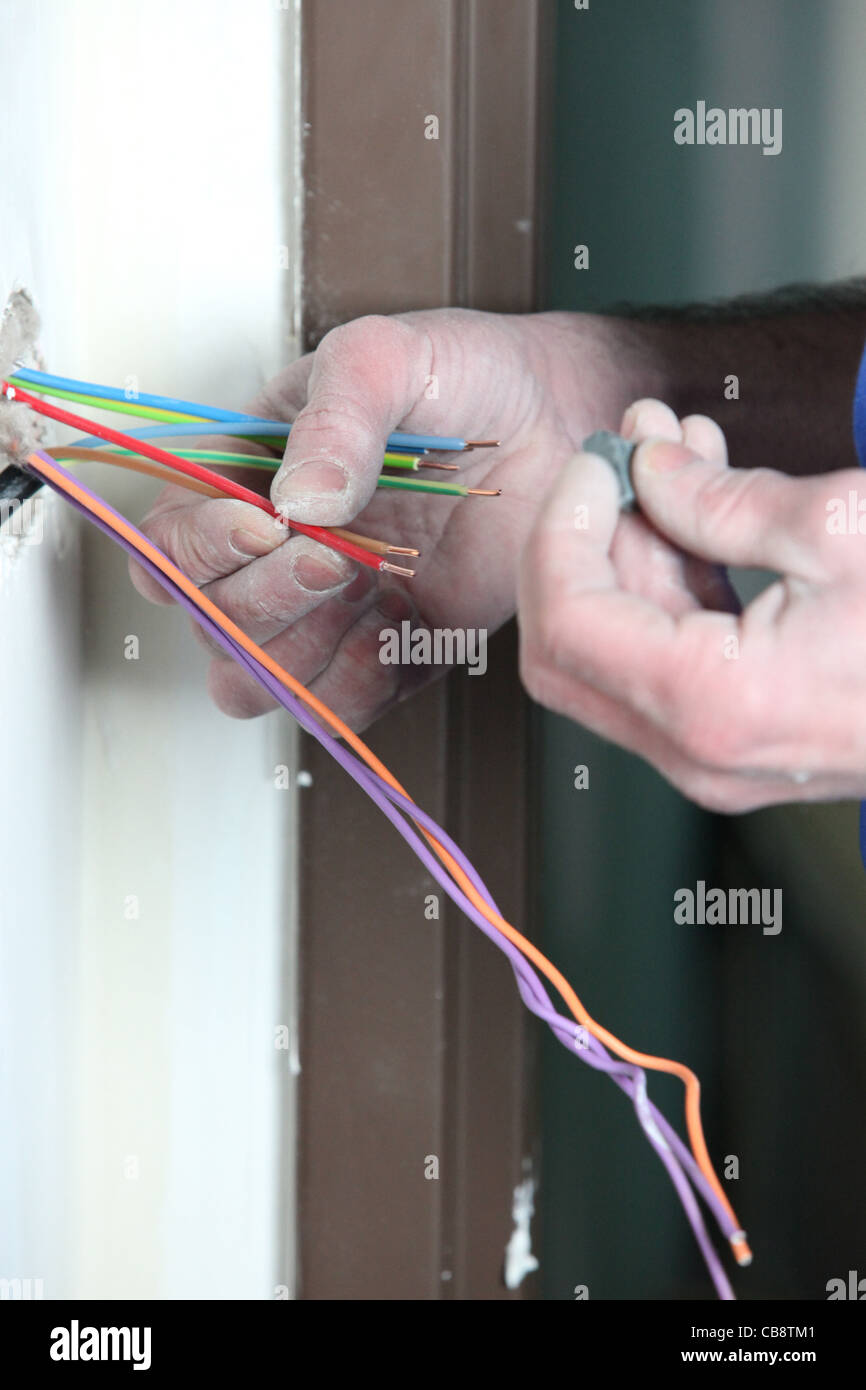Hands of electrician with wires Stock Photo - Alamy