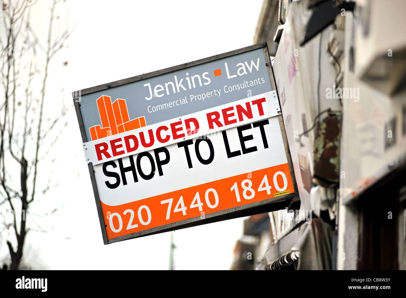 An agents board offering a shop to let and reduced rent Stock Photo - Alamy