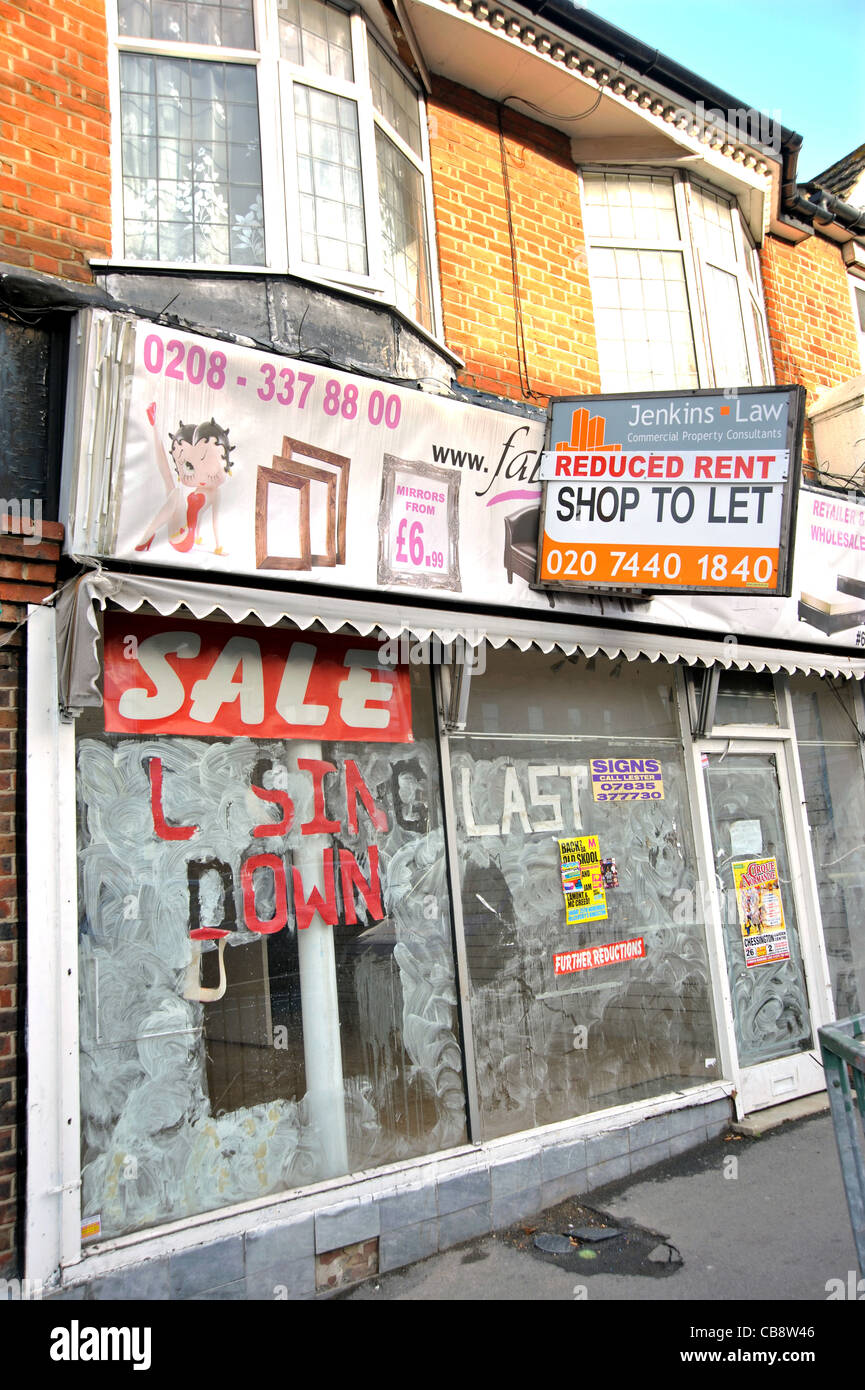 An empty shop in a Suburban London high street with 'closing down sale ...