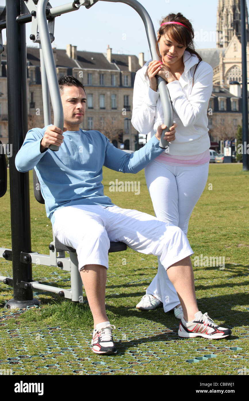 Couple doing gymnastics outdoors Stock Photo - Alamy