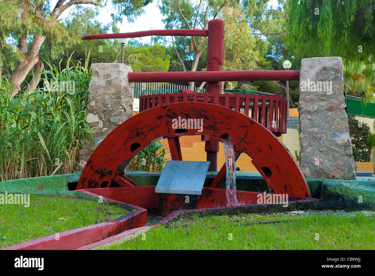 Traditional old water mill rotating with flowing water Stock Photo - Alamy