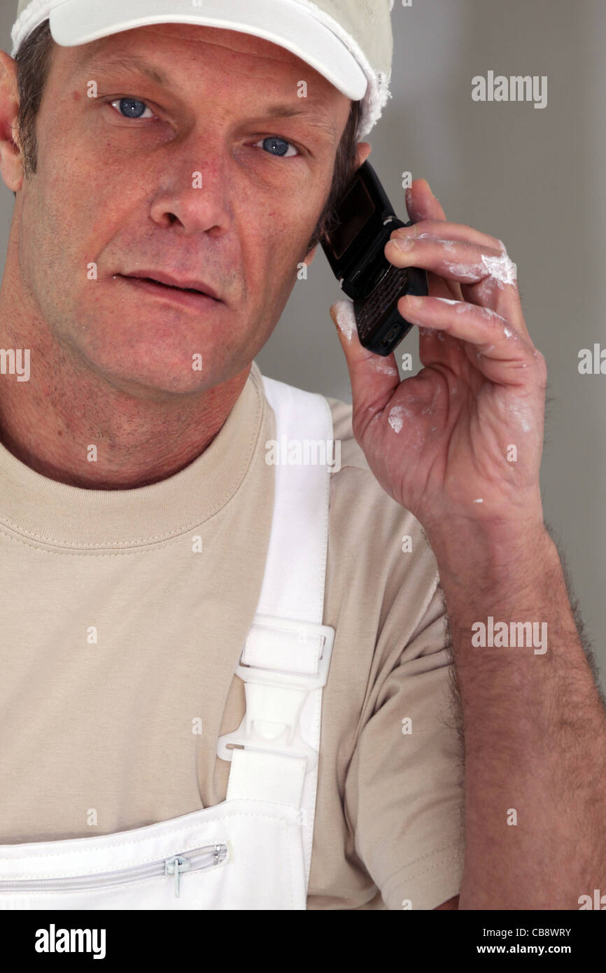 Painter making telephone call Stock Photo - Alamy