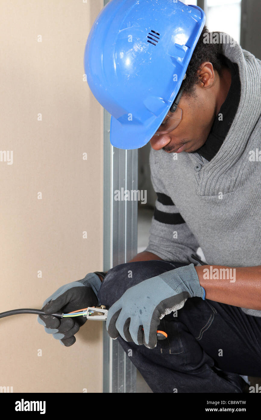 Electrician repairing electrical wires Stock Photo - Alamy