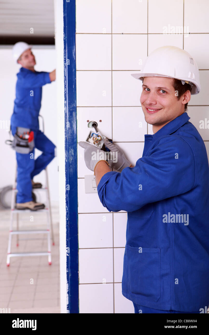 Man fixing an electrical outlet Stock Photo - Alamy