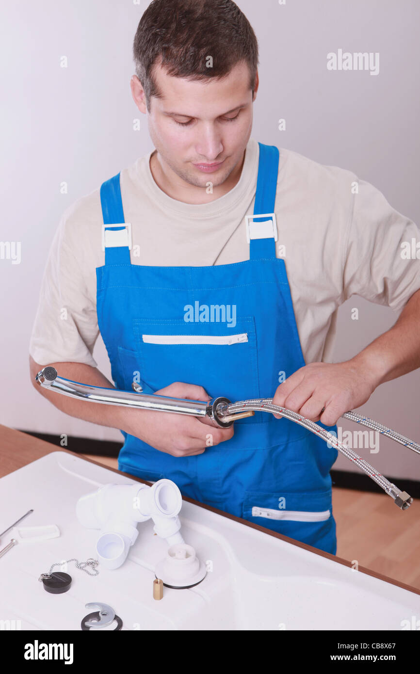 Plumber repairing a sink Stock Photo - Alamy