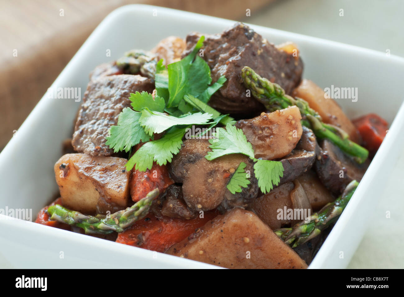 Homemade beef stew with cilantro garnish Stock Photo - Alamy