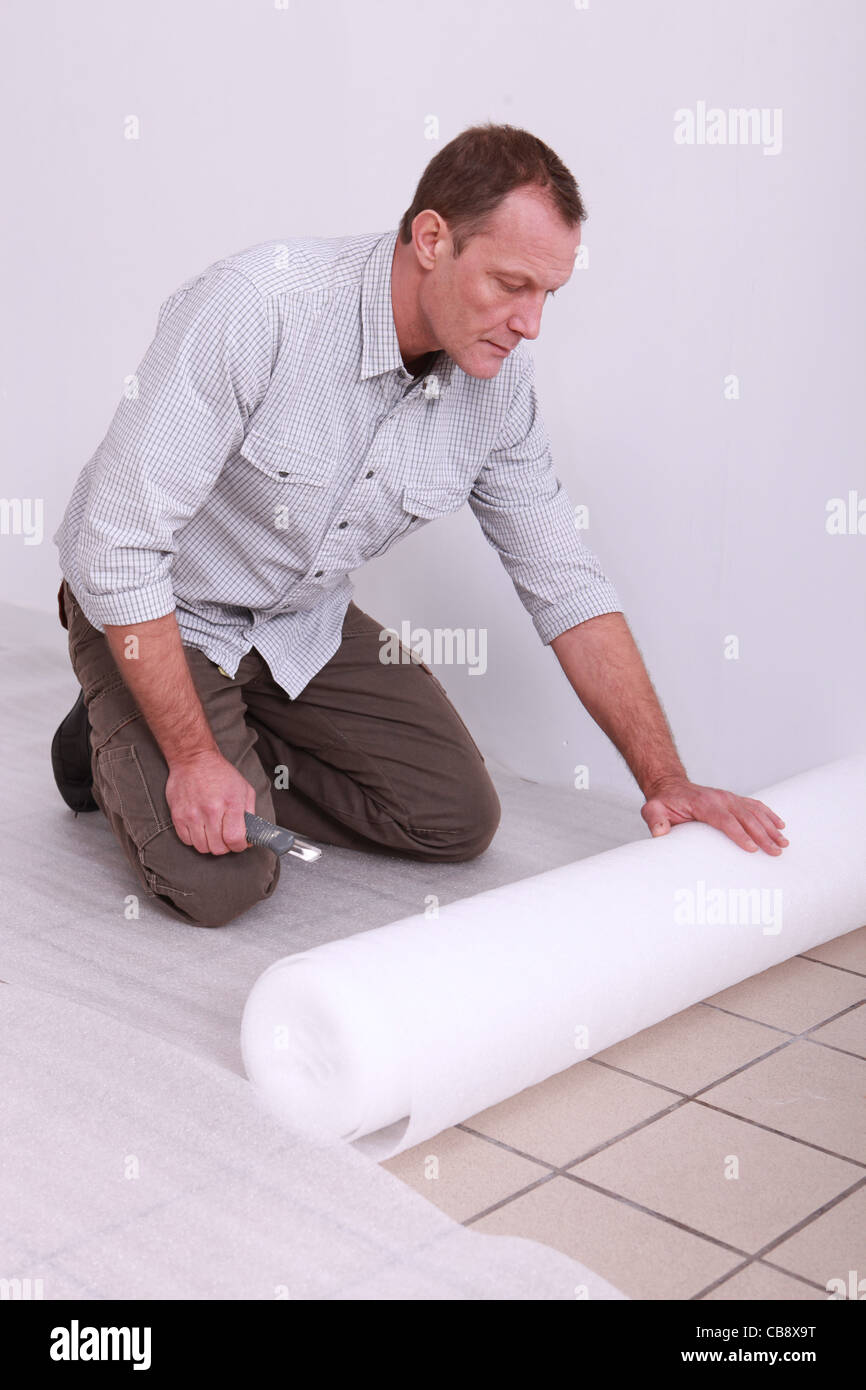 Laborer changing tiles Stock Photo - Alamy