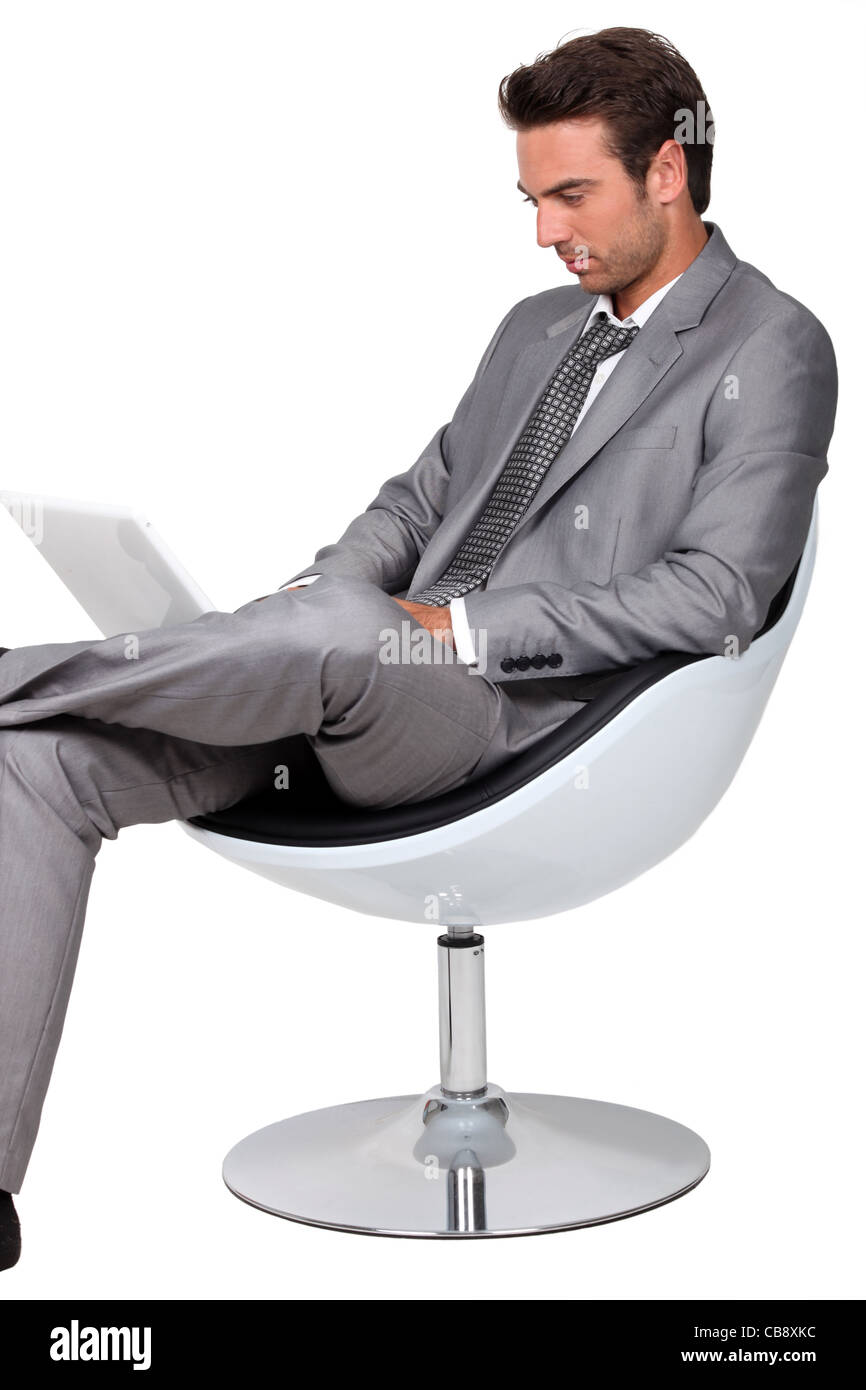 Smart young man using a laptop Stock Photo - Alamy