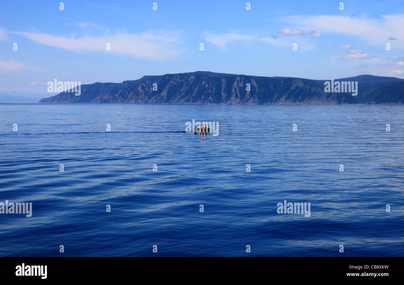 Lake Baikal, summer. Motor boat in middle of the lake Stock Photo - Alamy