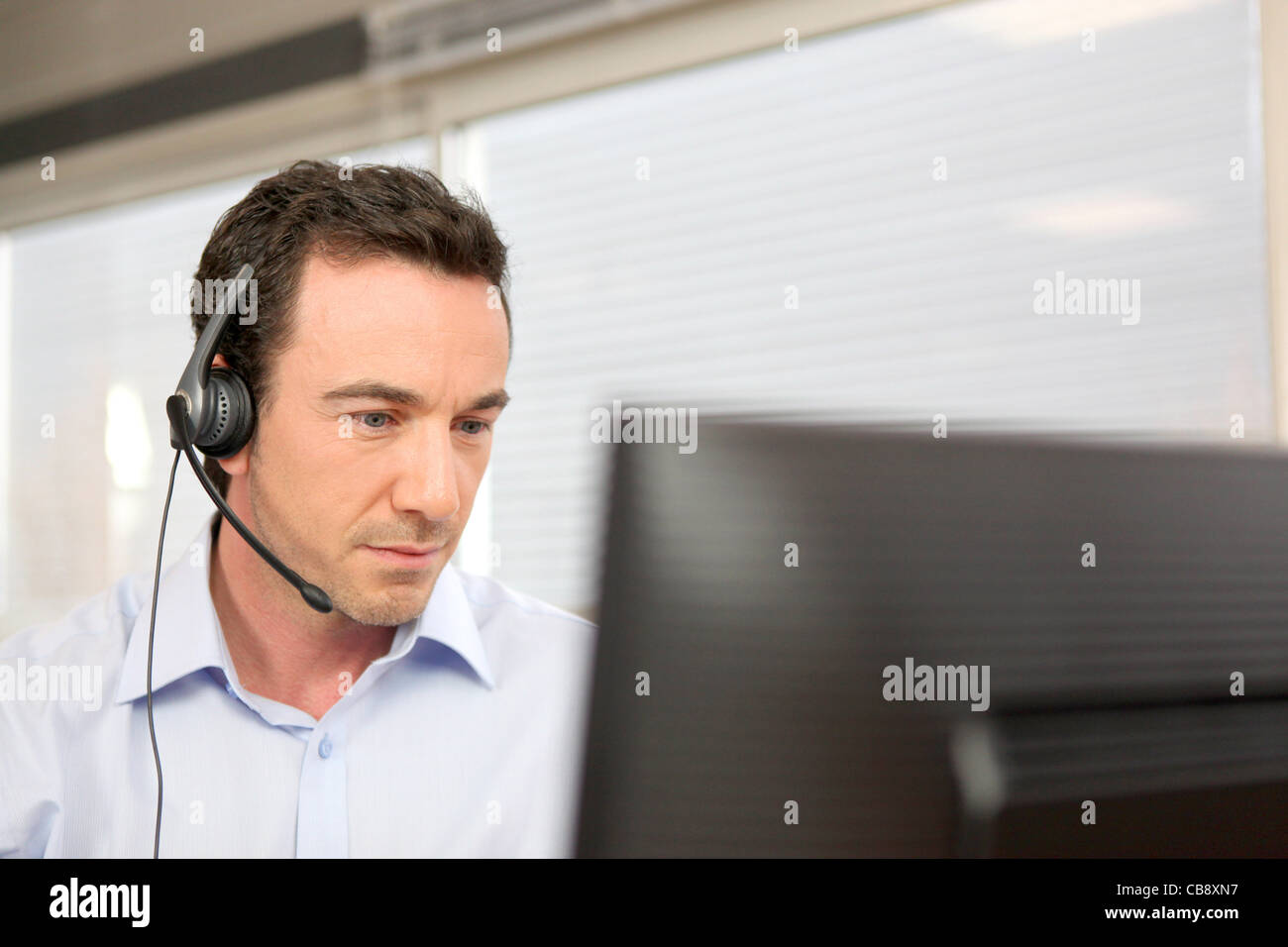 Young businessman speaking over headset hi-res stock photography and ...