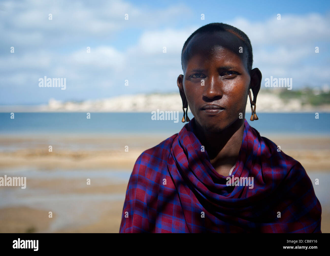 Masai Man Keeper With Shaven Head And Traditional Clothes With Sea In ...