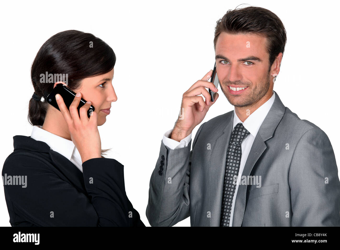 Two businesspeople making simultaneous calls Stock Photo - Alamy