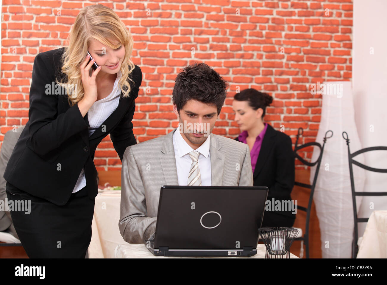 Man and woman looking at a laptop computer Stock Photo - Alamy