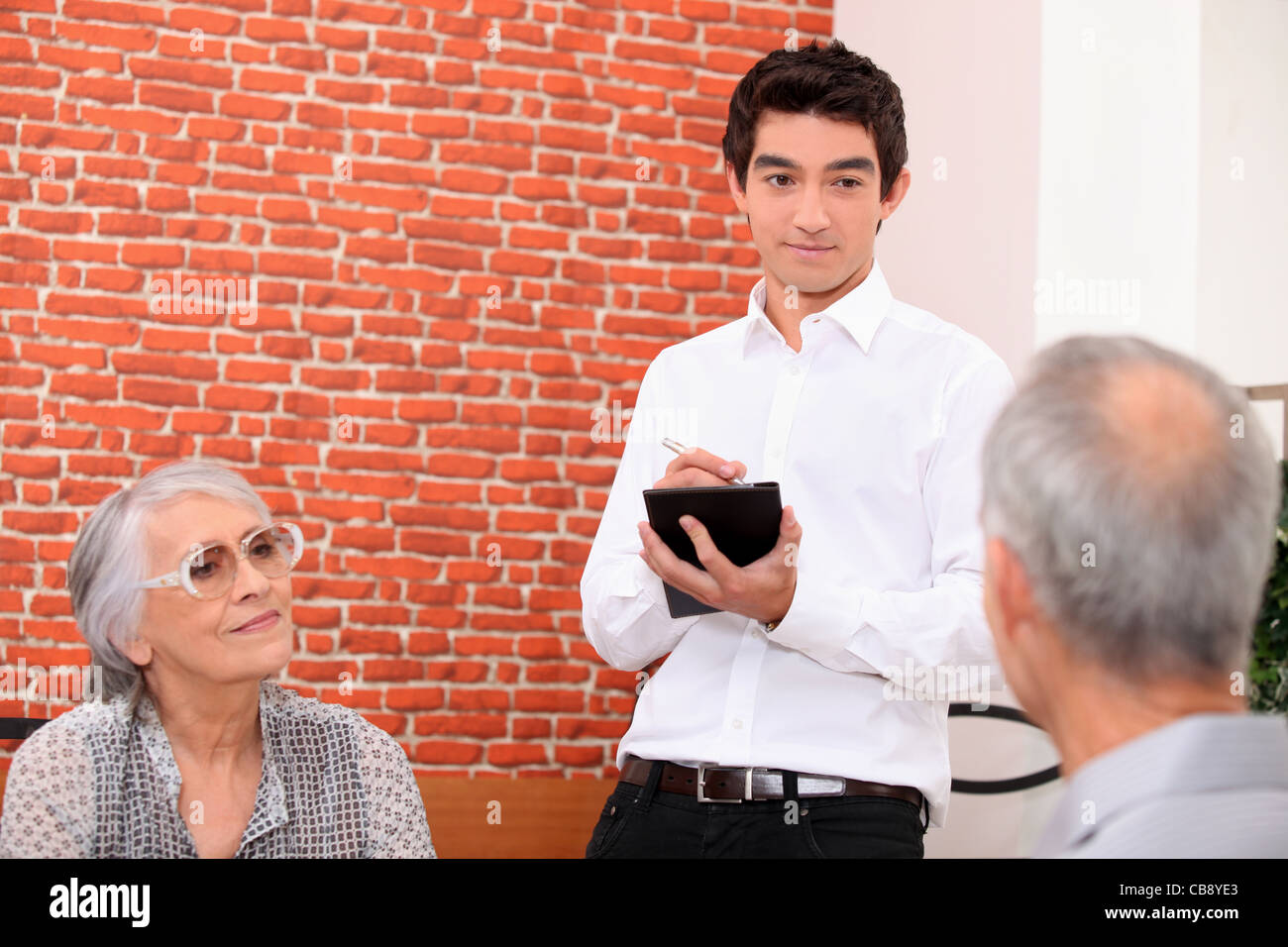 waiter in restaurant taking order Stock Photo - Alamy
