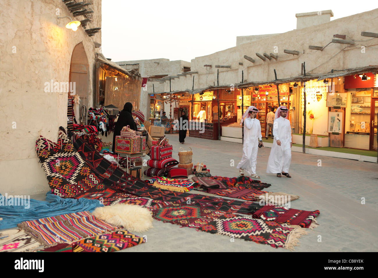 Shoppers outside a traditional textile shop in Souq Waqif, Doha, Qatar ...
